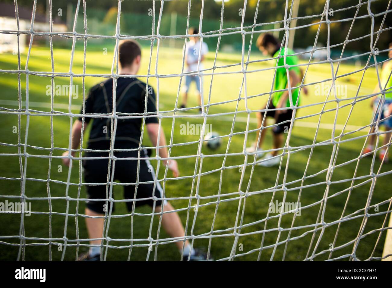 Soccer pitch - players playing soccer on a synthetic grass pitch Stock ...
