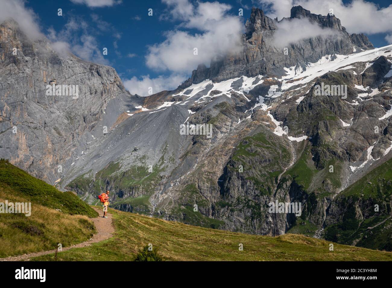 Pretty, female hiker/climber in a lovely alpine setting of Swiss Alps ...