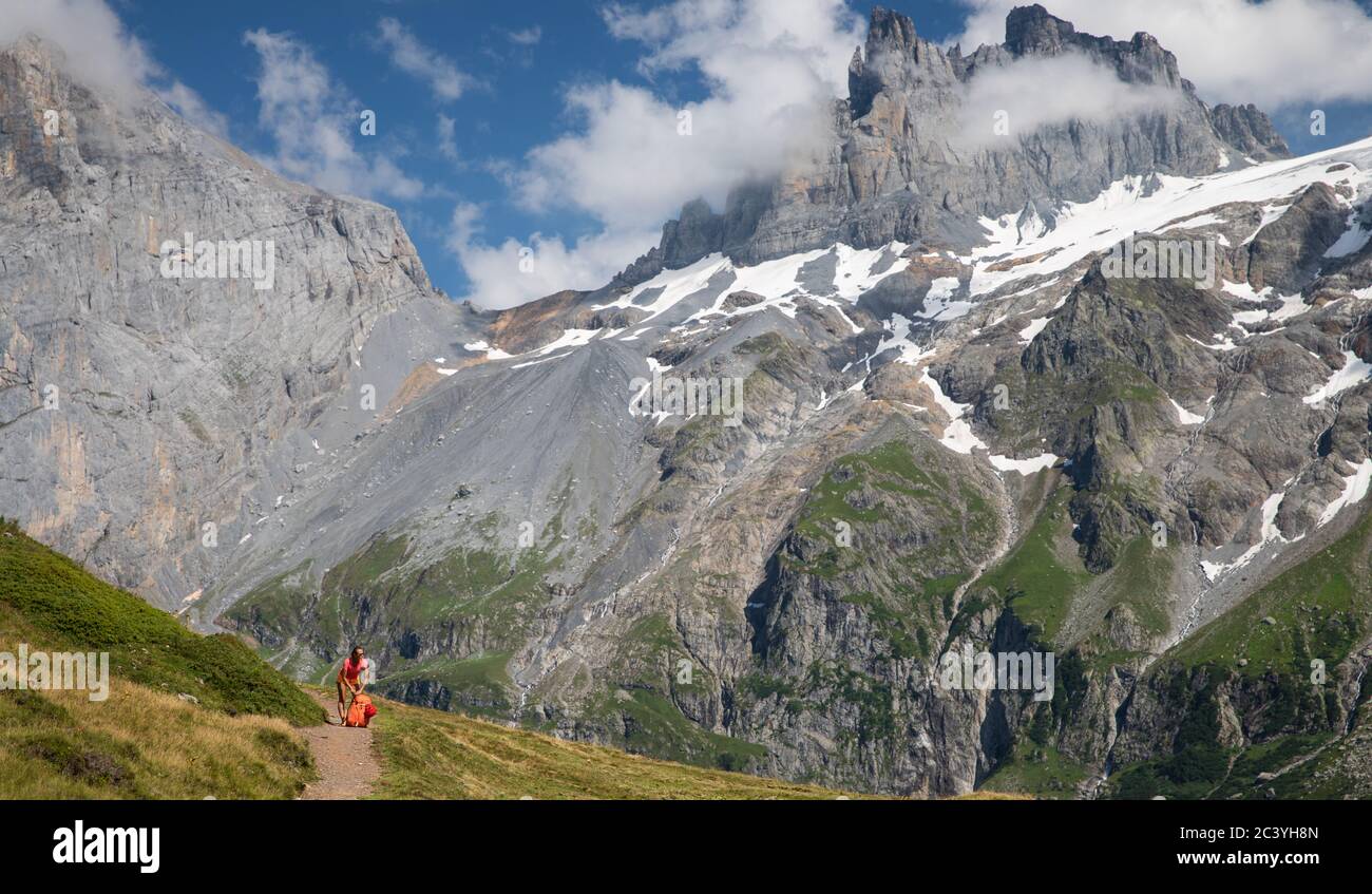 Pretty, female hiker/climber in a lovely alpine setting of Swiss Alps ...