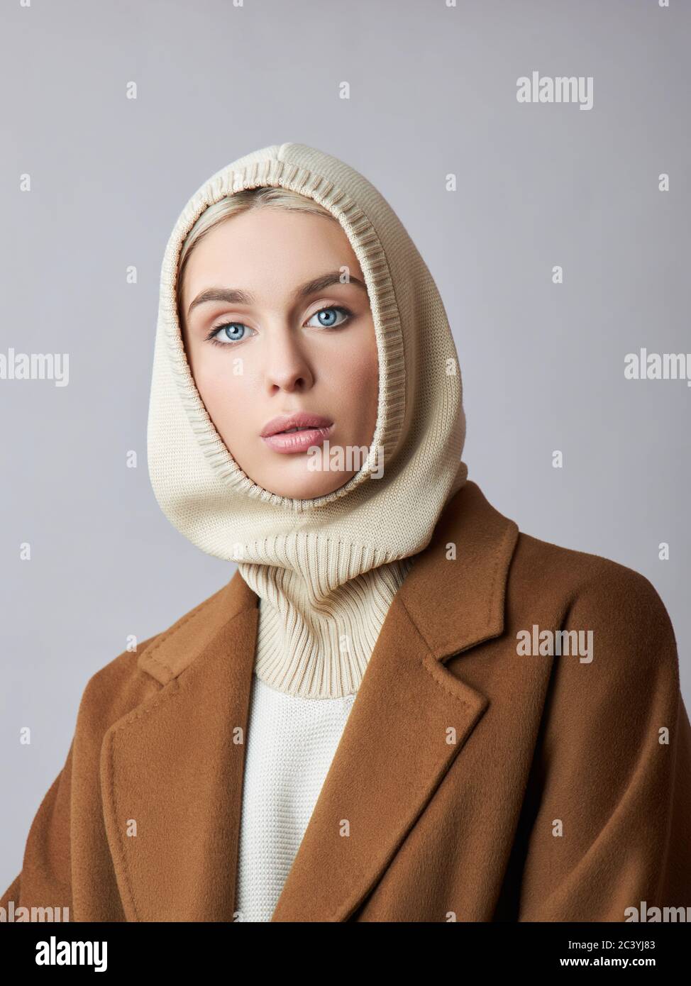European Muslim woman with a blonde hair in a bonnet hood dressed on ...