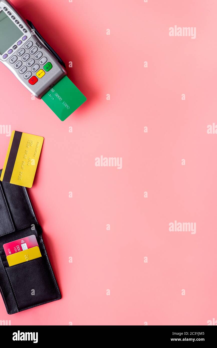 Payment by credit card. Terminal on pink background top-down copy space ...