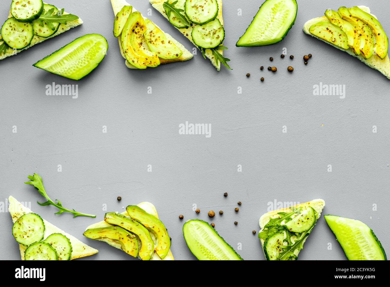 green veggie sandwiches with avocado on grey desk from above frame copy ...