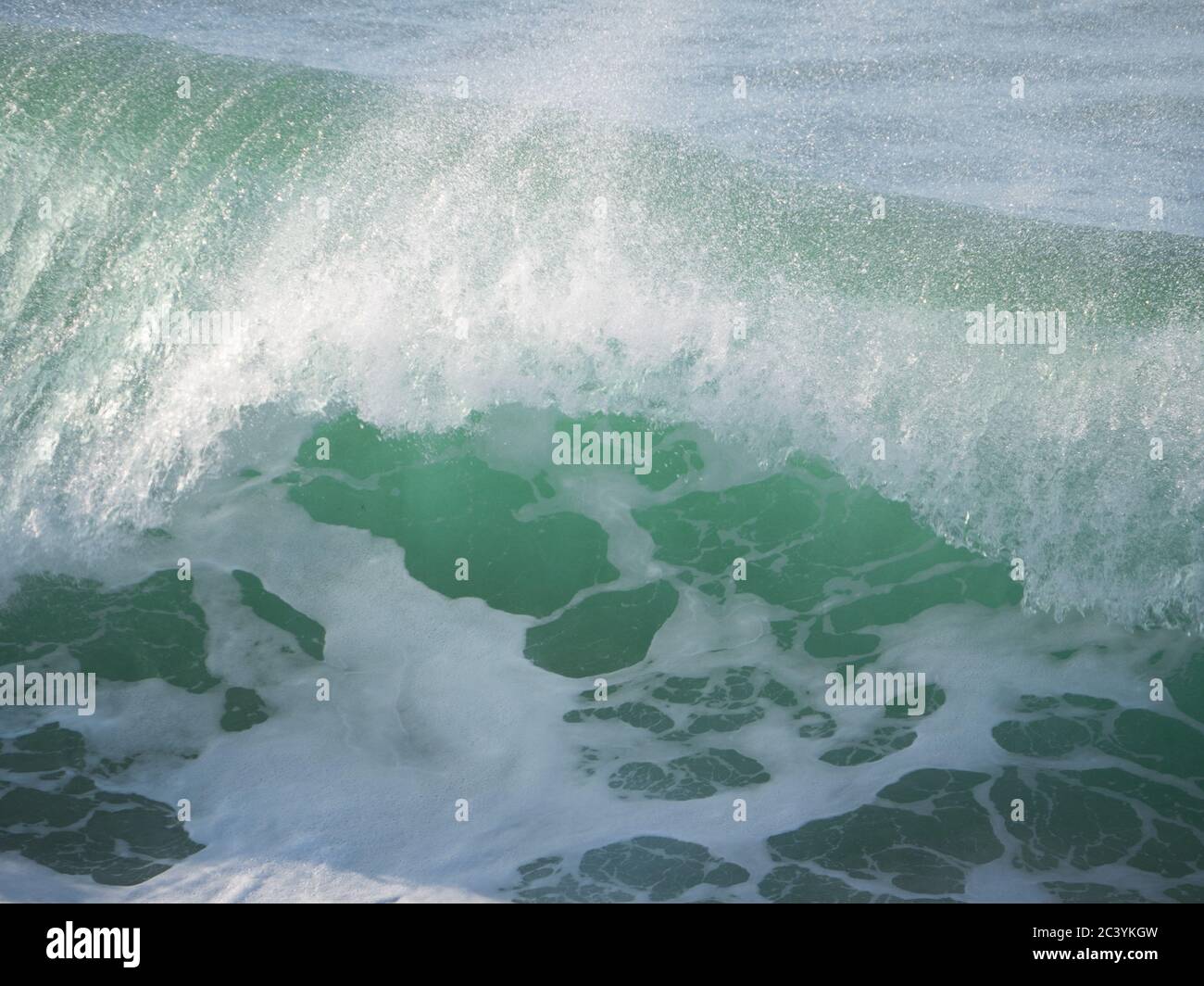 Closeup ocean Waves and salt water, sun illuminating a blue green sea ...