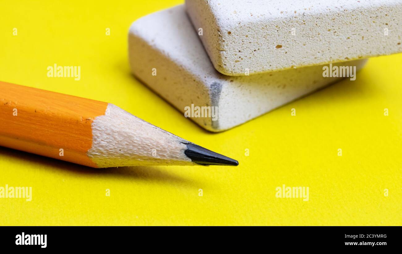 Two erasers and pencil on a yellow background Stock Photo - Alamy