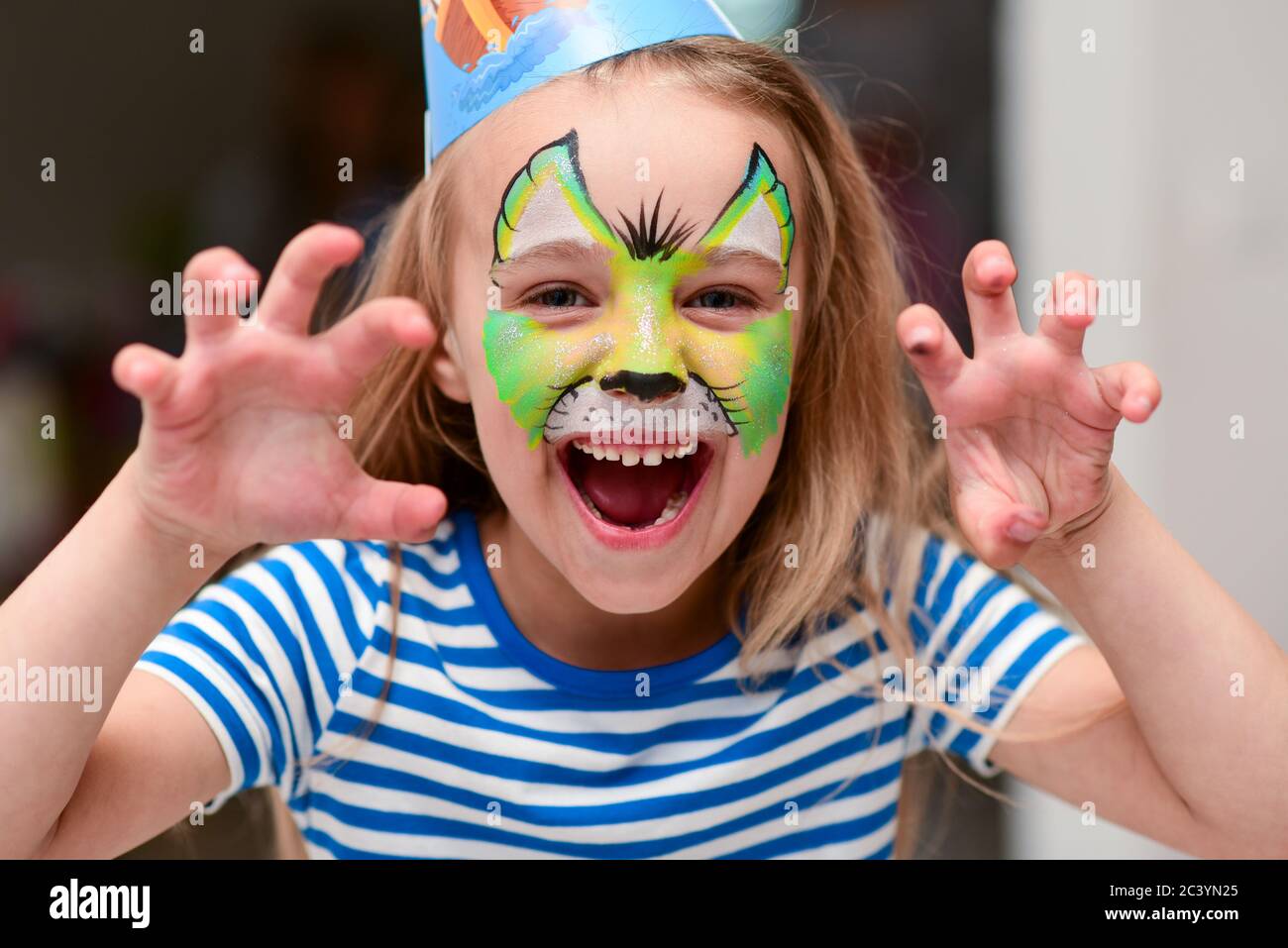 Child in makeup growls with claws hands Stock Photo - Alamy