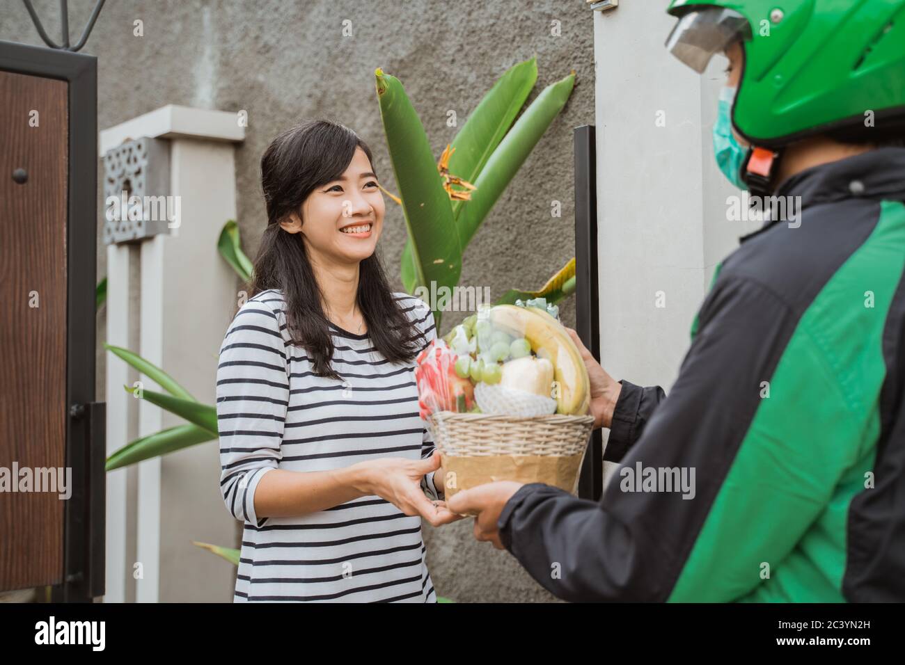 portrait of asian delivery man delivering fruit parcel Stock Photo - Alamy