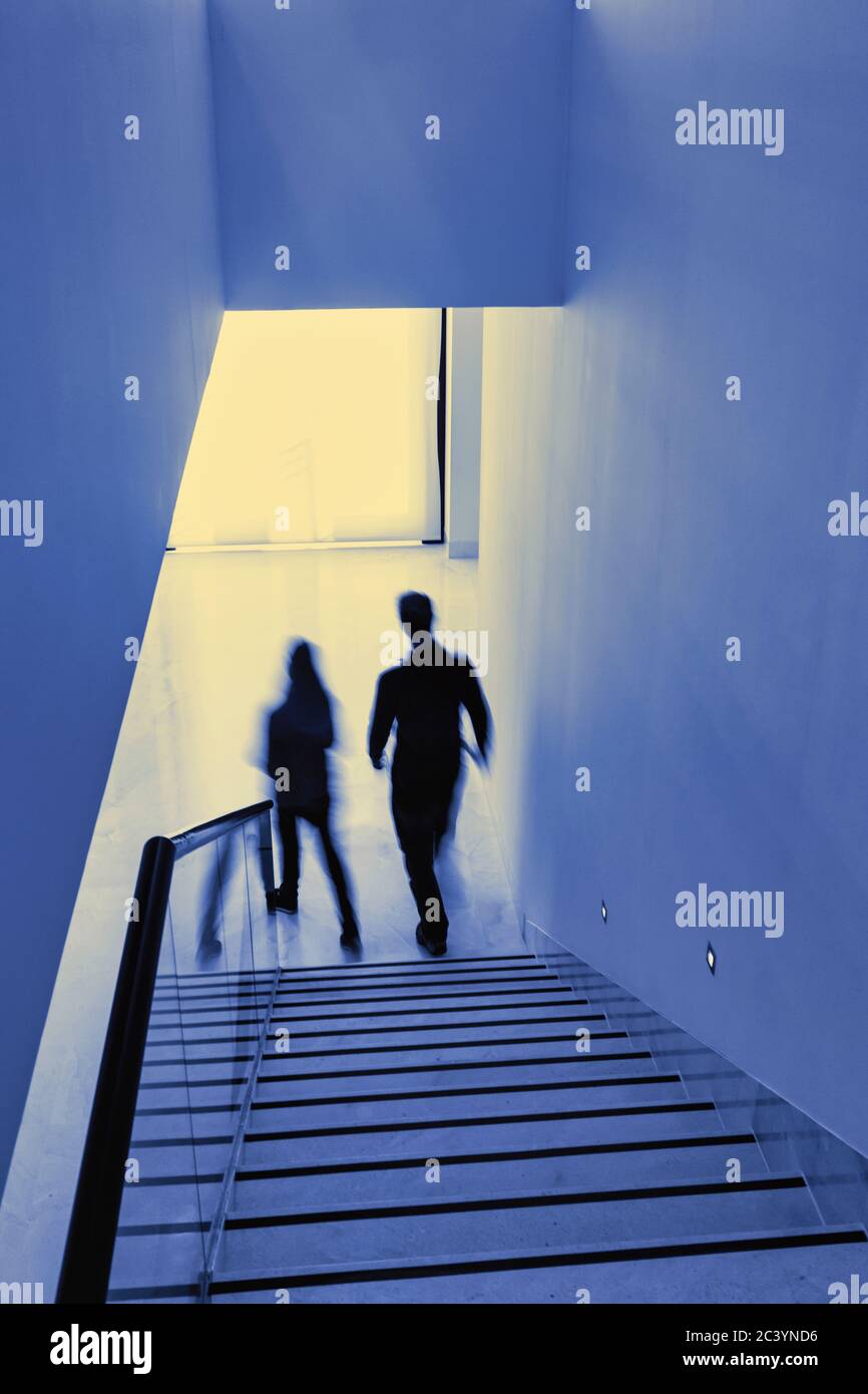 Woman descending stairs hi-res stock photography and images - Alamy