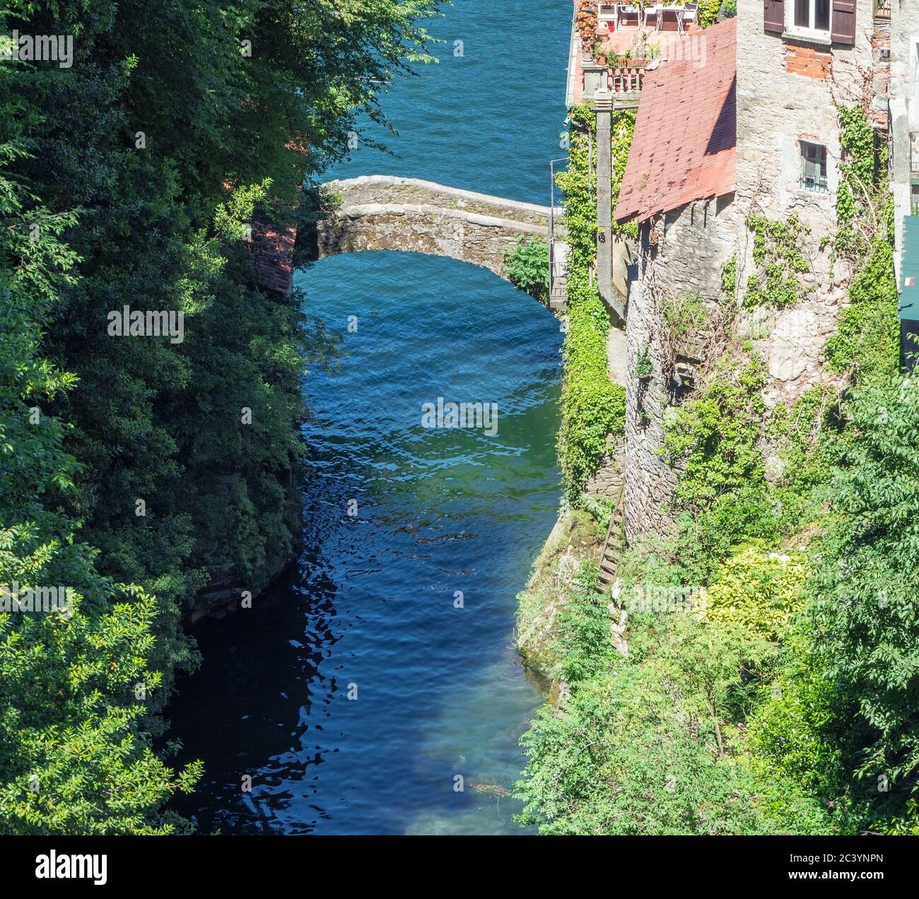 medieval stone arch bridge. Nesso - Italy, tourist resort of Como Lake ...