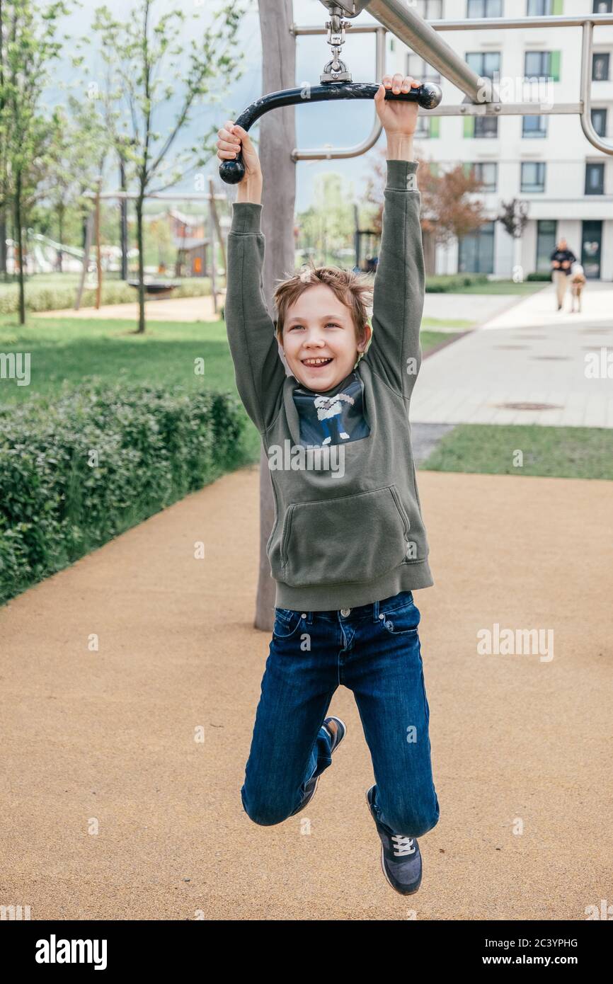 Cute boy is playing on playground Stock Photo - Alamy
