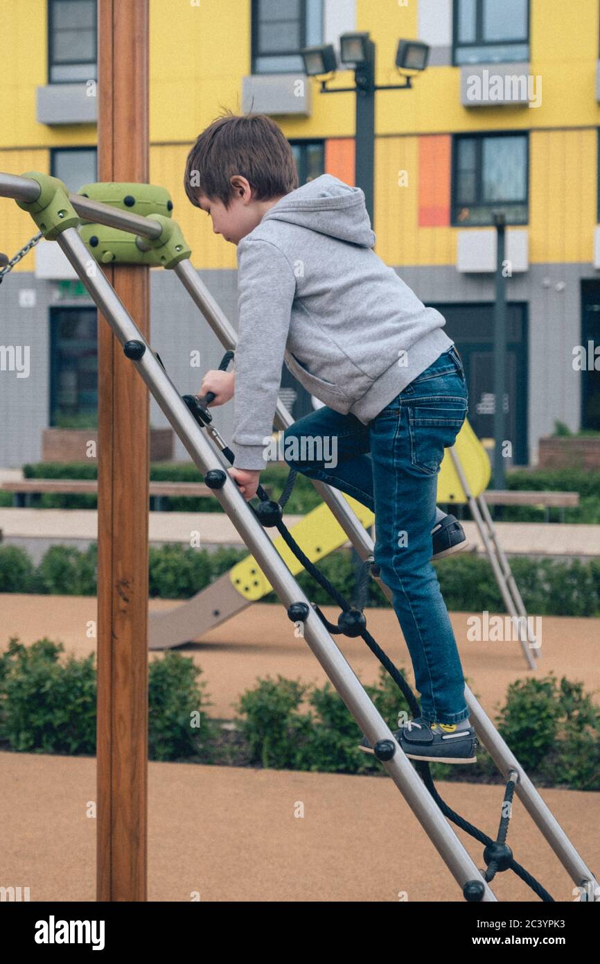 Cute boy is playing on playground Stock Photo - Alamy