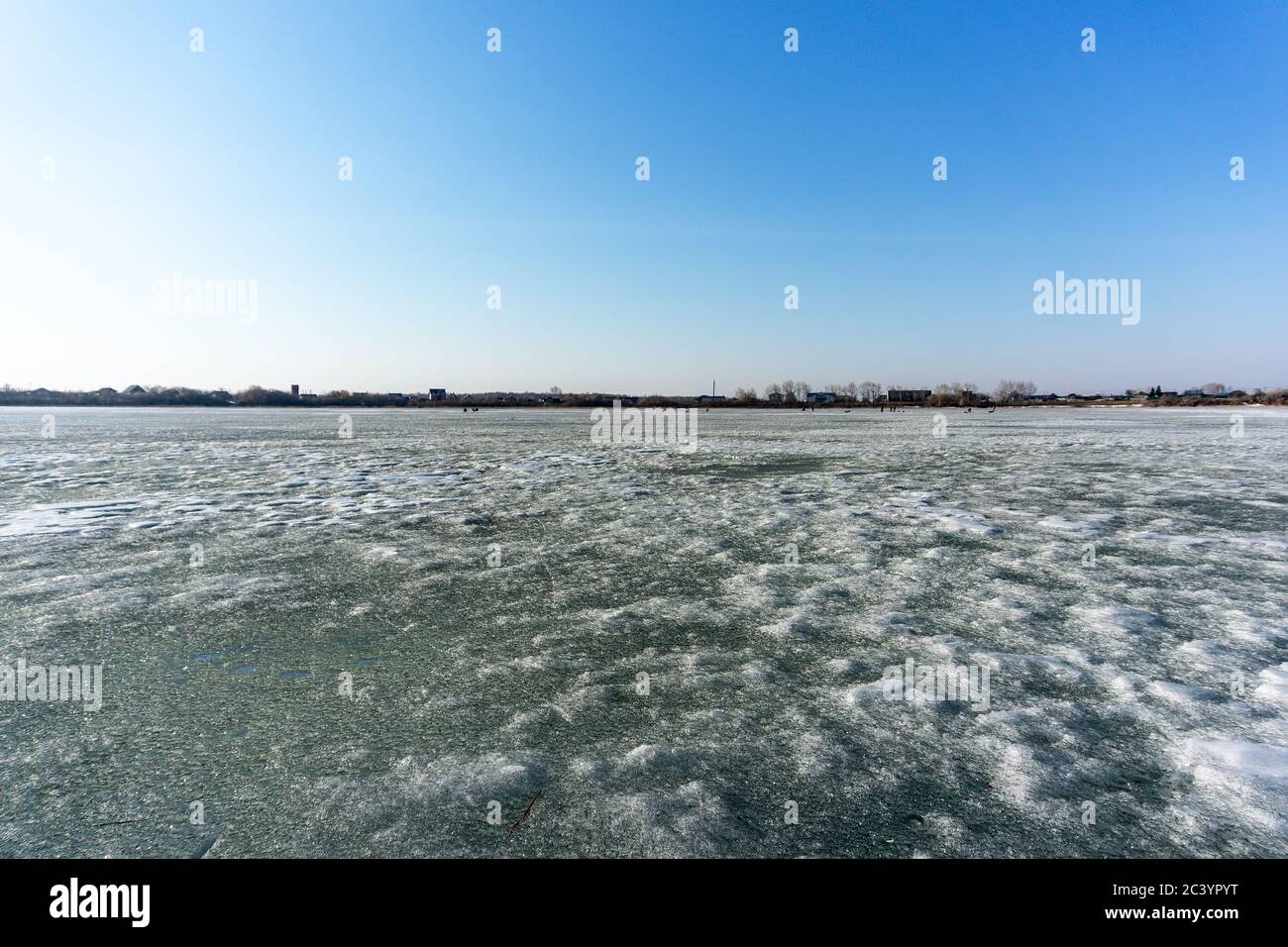 winter fishing fishermen catching fish under the ice in winter ice ...