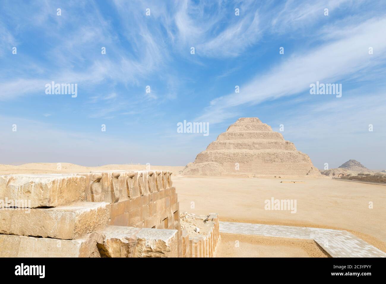Wall engraved with images of cobra snakes next to stepped pyramid ...