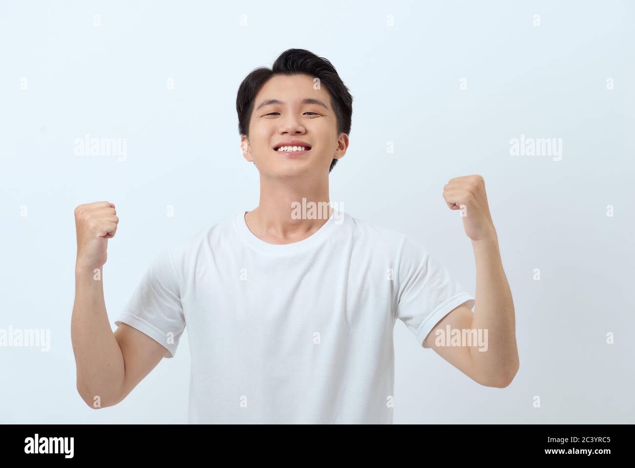 Happy winner. Happy young handsome man gesturing and keeping mouth open ...