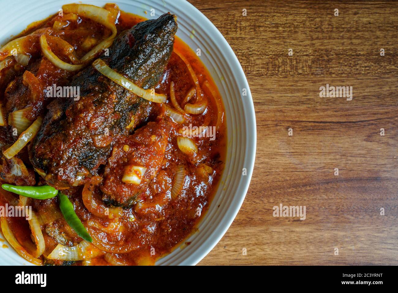 Fried silver catfish cooked with spicy sambal red chilli and onion with ...