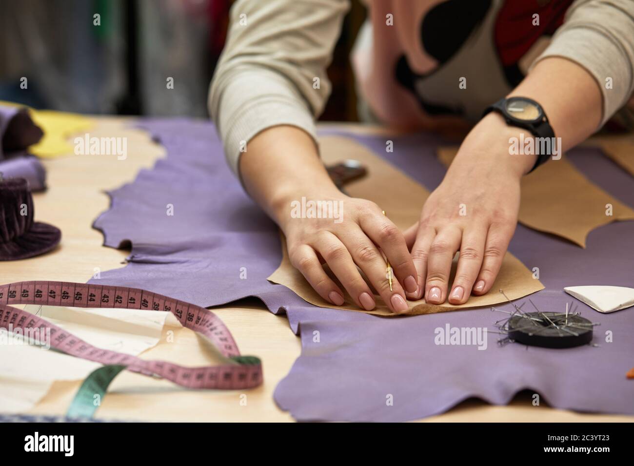 Tailor woman is working at table in atelier Stock Photo - Alamy