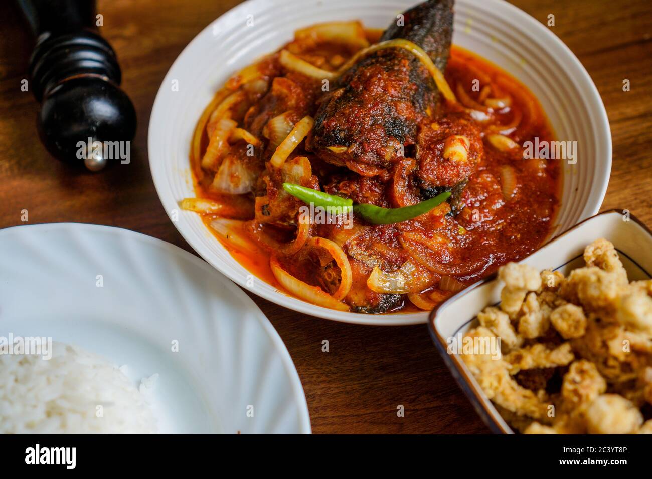 Fried silver catfish cooked with spicy sambal red chilli and onion with ...