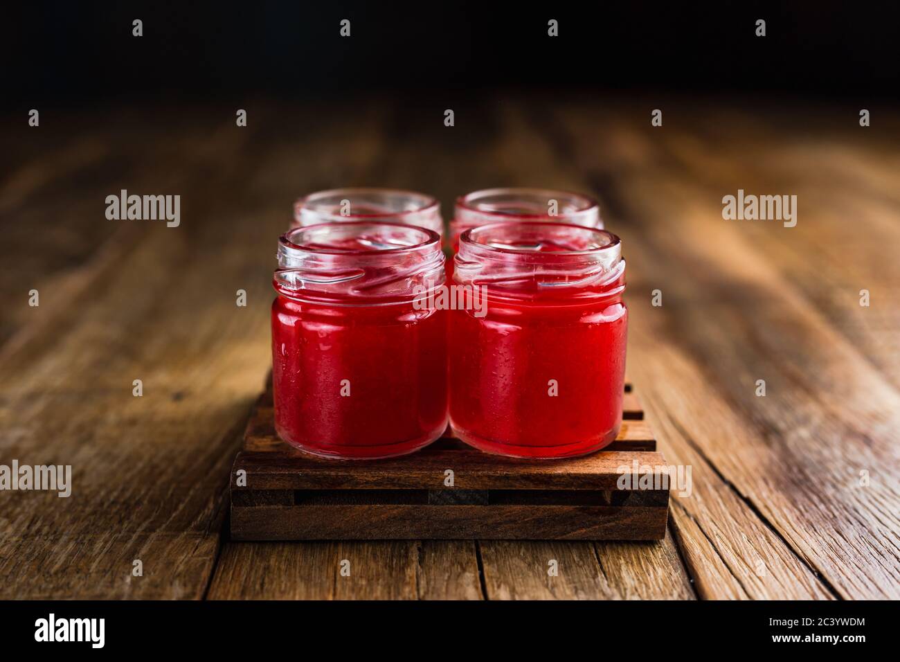 Red colored alcoholic shooters, or shot drinks on wooden table Stock ...
