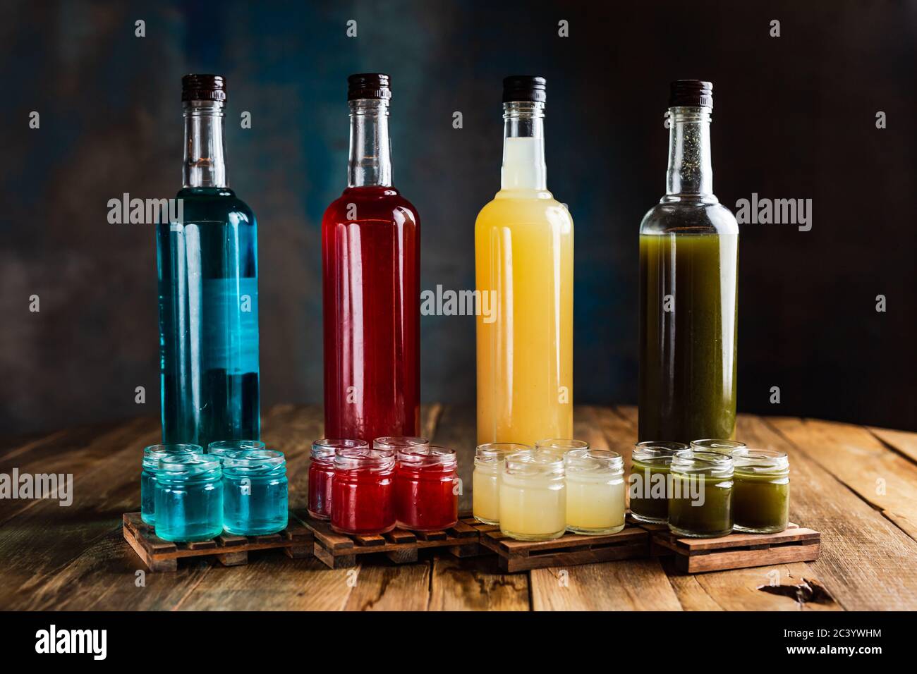 Different kinds of alcoholic shooters or shots with bottles, red, green ...