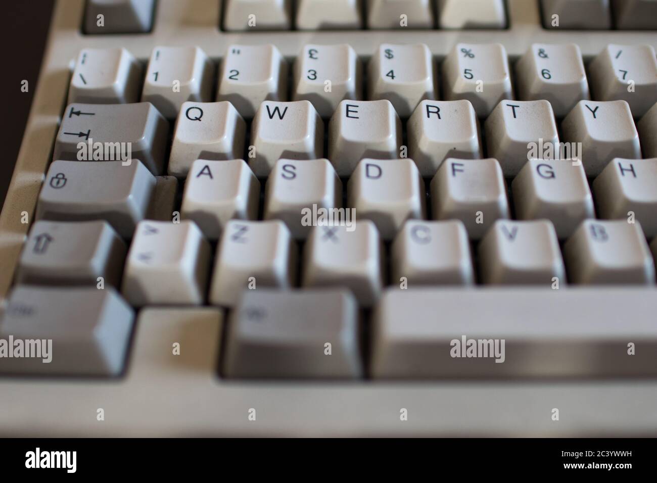 QWERTY Button on old keyboard with mechanical buttons of ivory and gray ...