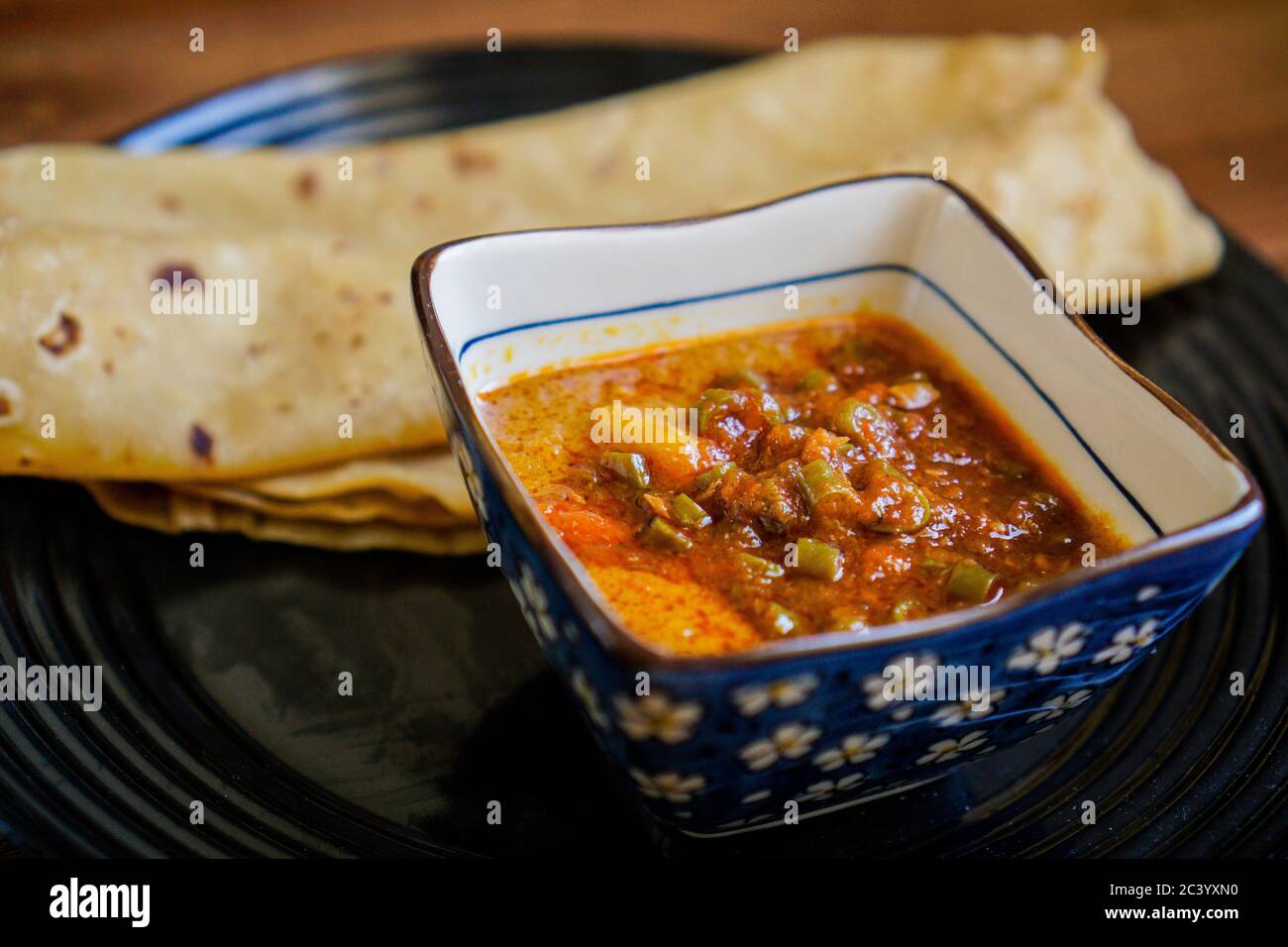 Chapati with chicken curry mix with sardine sambal Stock Photo - Alamy