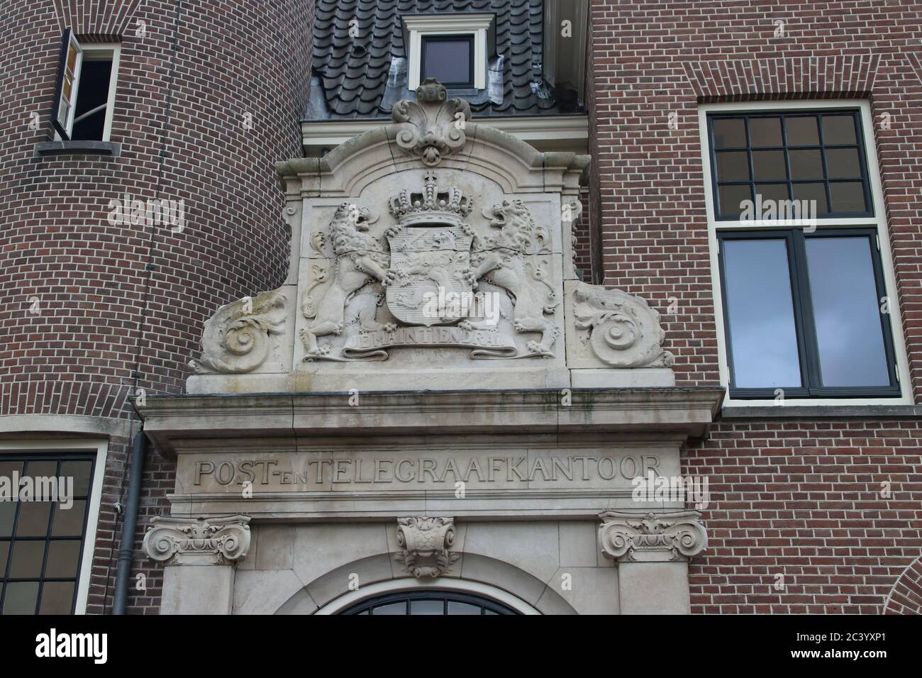 Crest of the kingdom of the Netherlands above an entrance to an old ...
