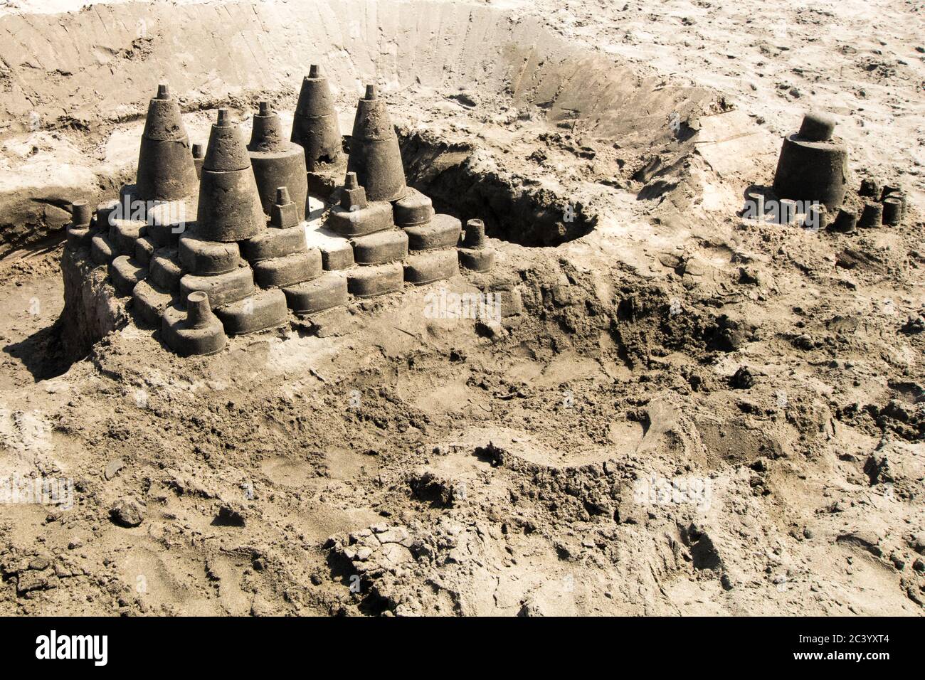 Complex sandy castle on the beach under construction Stock Photo - Alamy