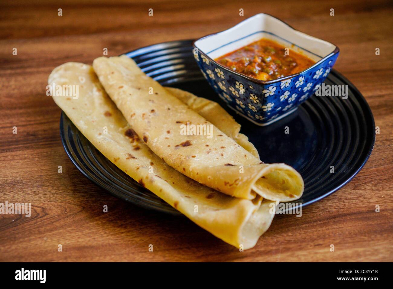 Chapati with chicken curry mix with sardine sambal Stock Photo - Alamy