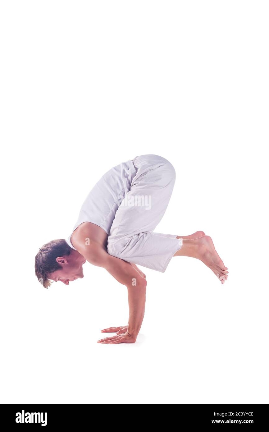Man practicing yoga doing the " crow pose " . Bakasana Stock Photo - Alamy