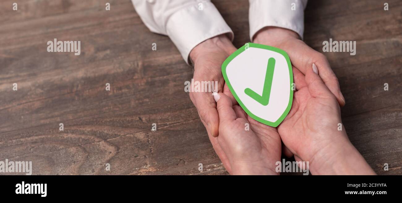 Concept of approved protection system with paper shield in hands Stock ...