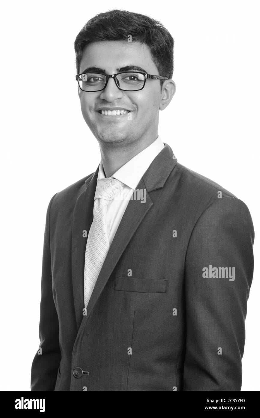 Portrait of happy young handsome Persian businessman wearing eyeglasses ...