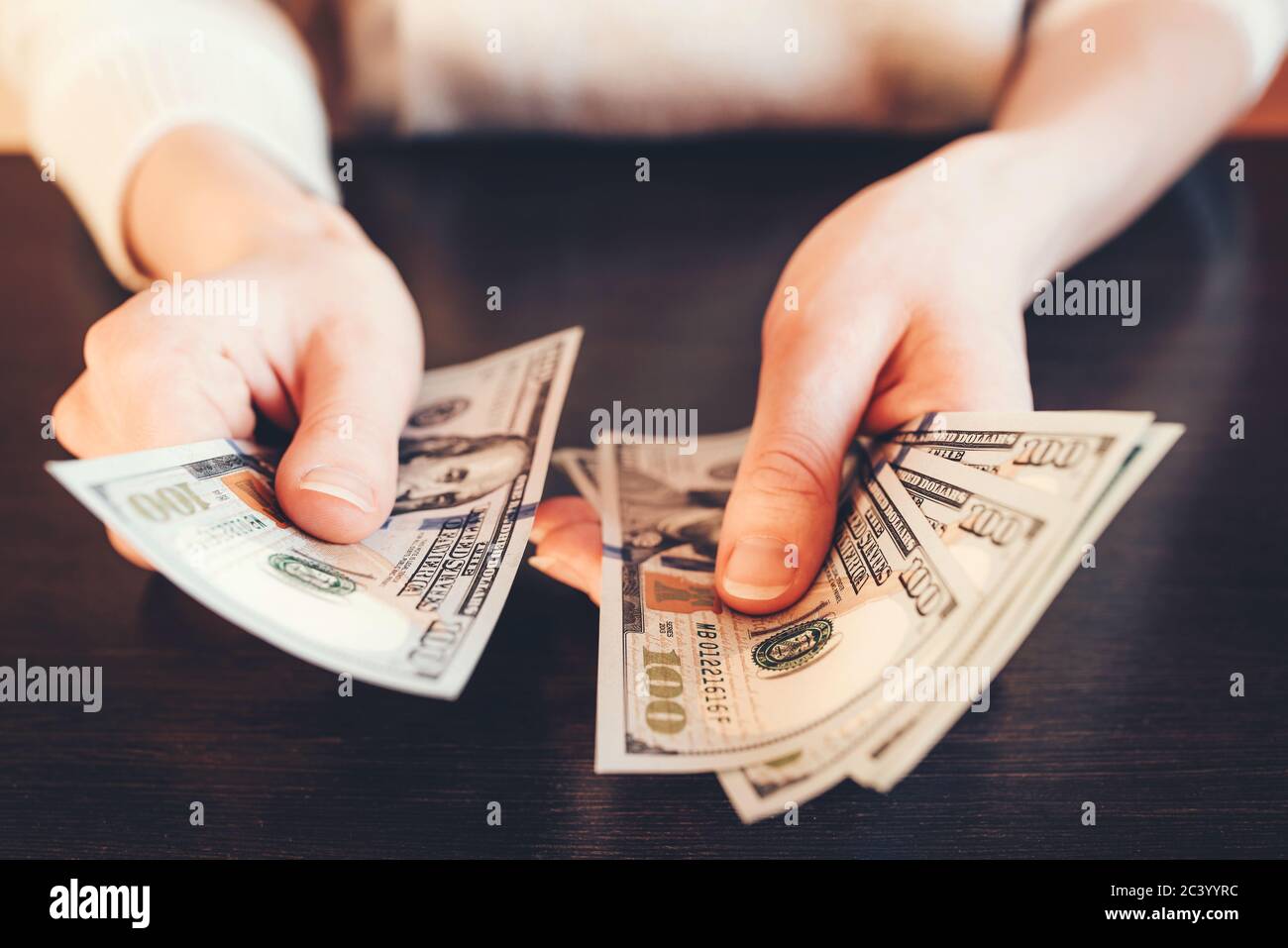 American cash dollars. Hundred-dollar bills in hand Stock Photo - Alamy