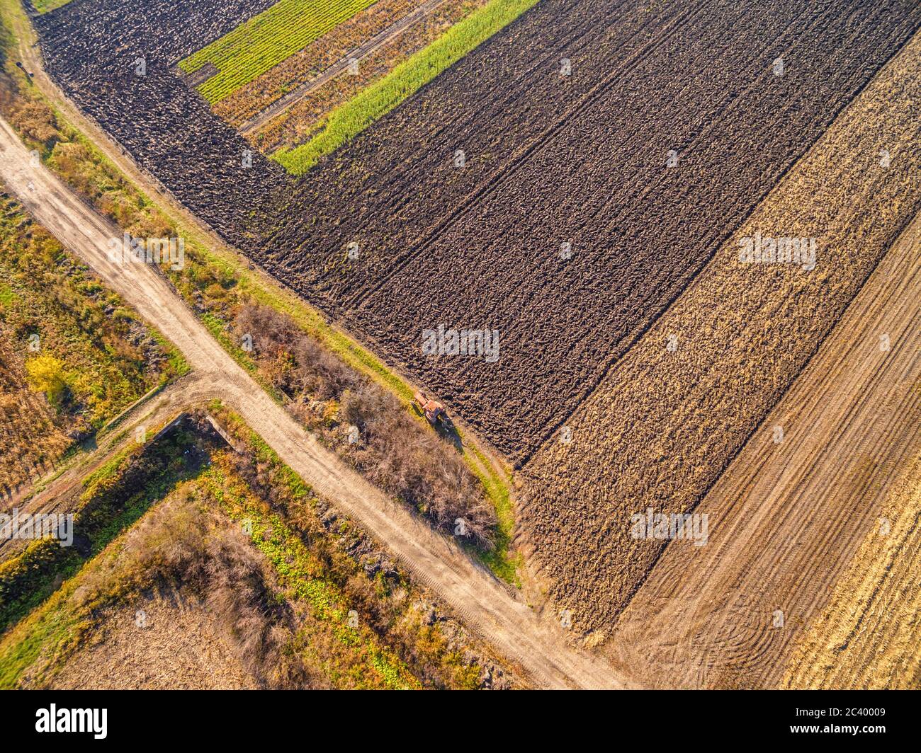 Aerial view of tractor ploughing the field Stock Photo - Alamy