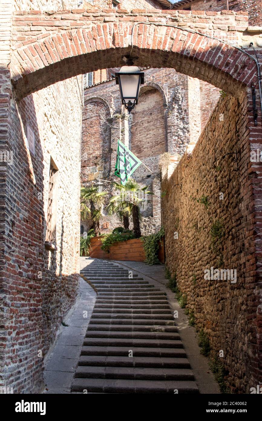 Brick arch with staircase and black and green flag in the center of an ...