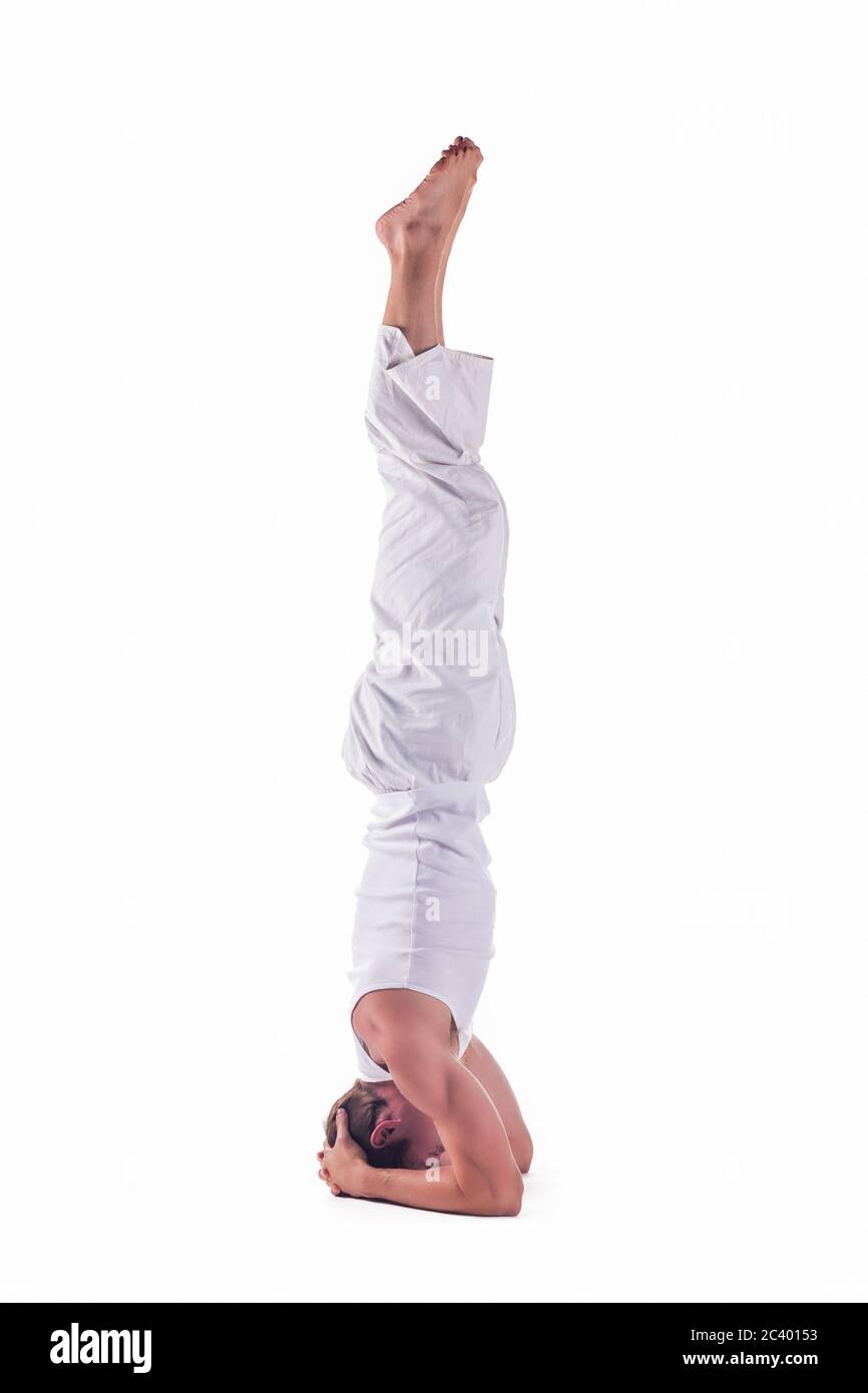 Man practicing yoga doing the " Supported Headstand " posture. Salamba ...