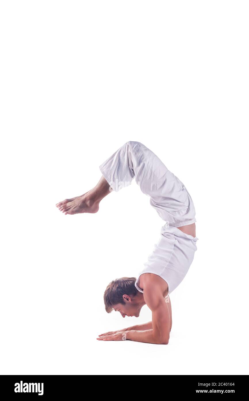 Man practicing yoga doing the " scorpion pose " posture. Vrschikasana ...