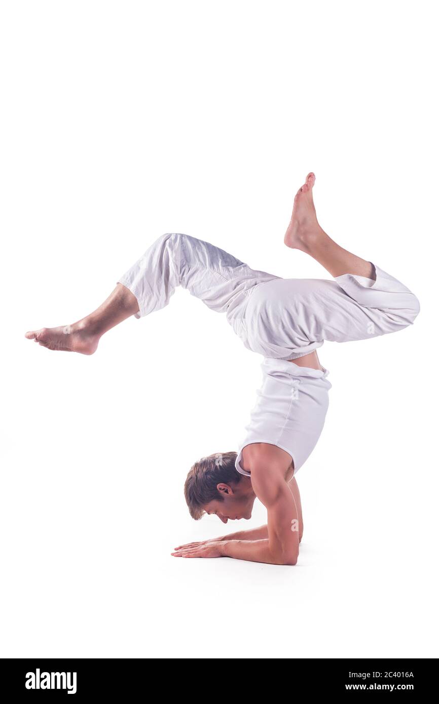 Man practicing yoga doing the " scorpion pose - variety" posture ...