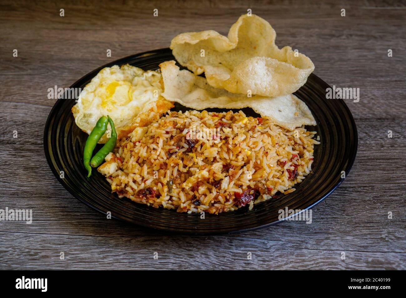 Spicy fried rice with dried chilli with fried egg and fish cracker ...