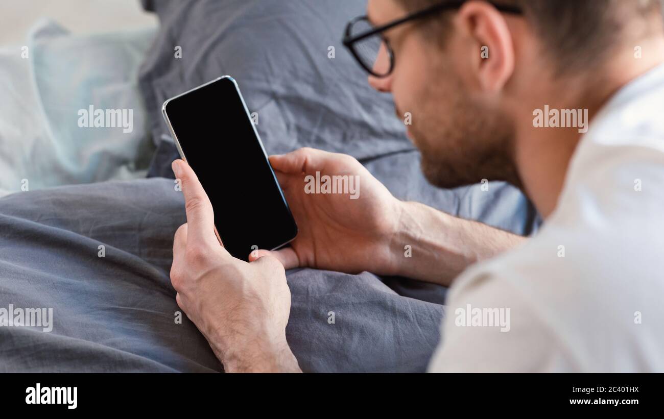 Man Using Cellphone Lying In Bed At Home, Mockup, Panorama Stock Photo ...