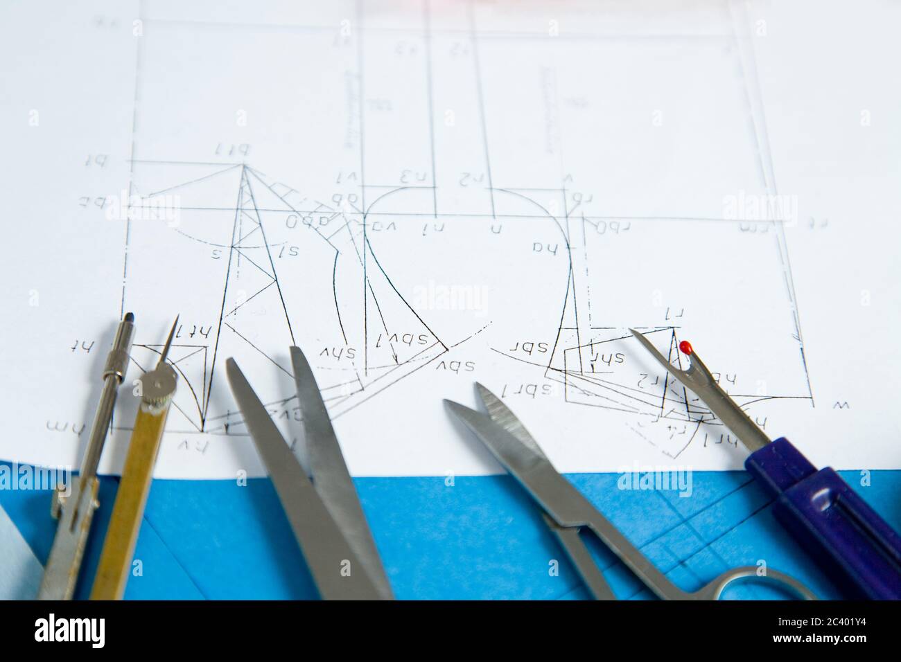 Sewing pattern for a dress with tools such as scissors and compasses ...