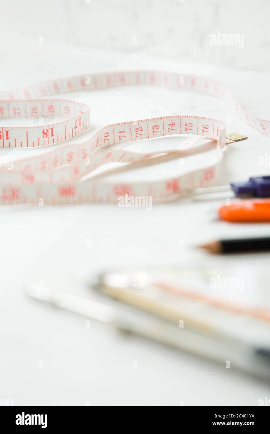Sewing pattern with white tape measure and drawing utensils Stock Photo ...