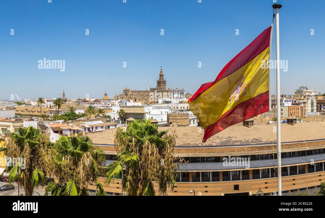 Spain flag and panoramic aerial view of Sevilla in a beautiful summer ...