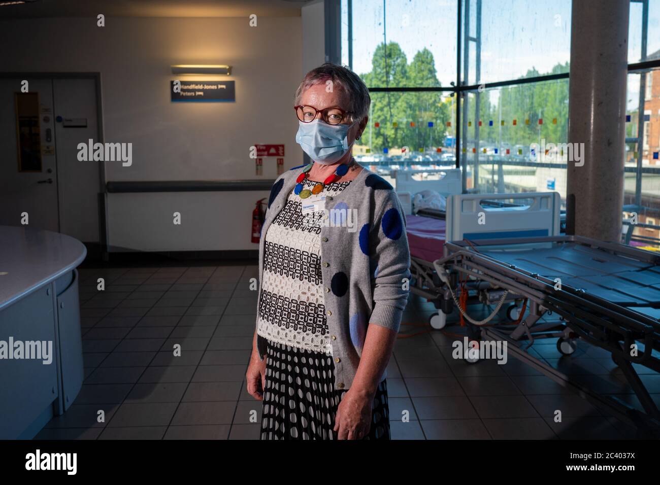 An NHS staff member wearing a protective mask poses for a portrait on ...