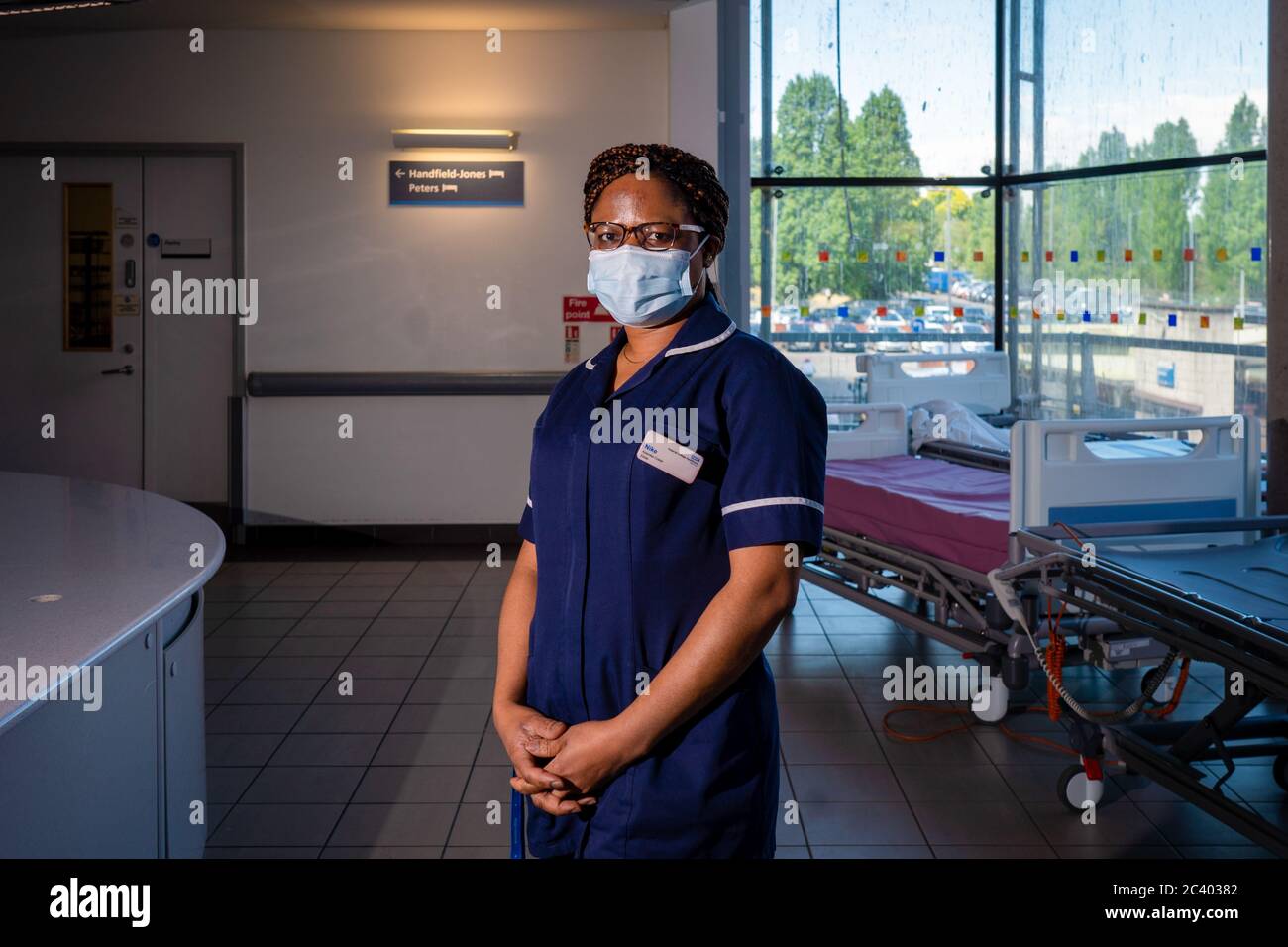 An NHS staff member wearing a protective mask poses for a portrait on ...