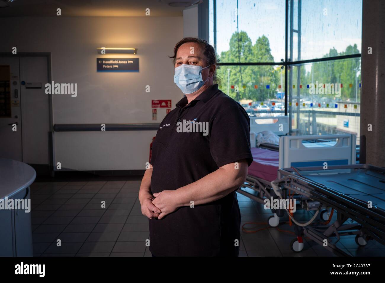 An NHS staff member wearing a protective mask poses for a portrait on ...