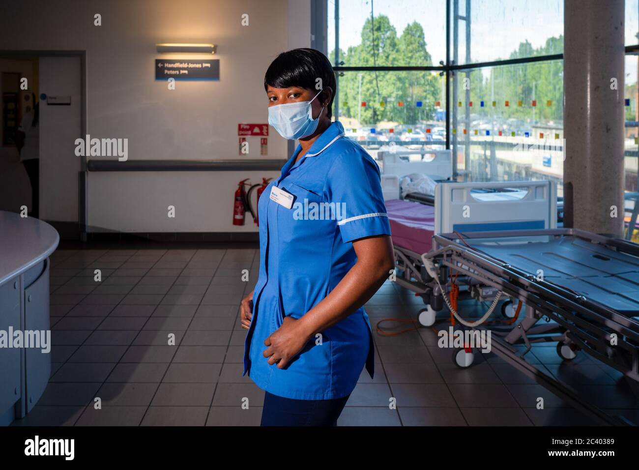 An NHS staff member wearing a protective mask poses for a portrait on ...