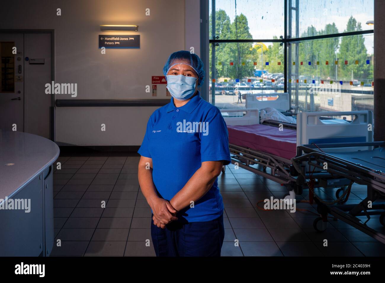 An NHS staff member wearing a protective mask poses for a portrait on a ...
