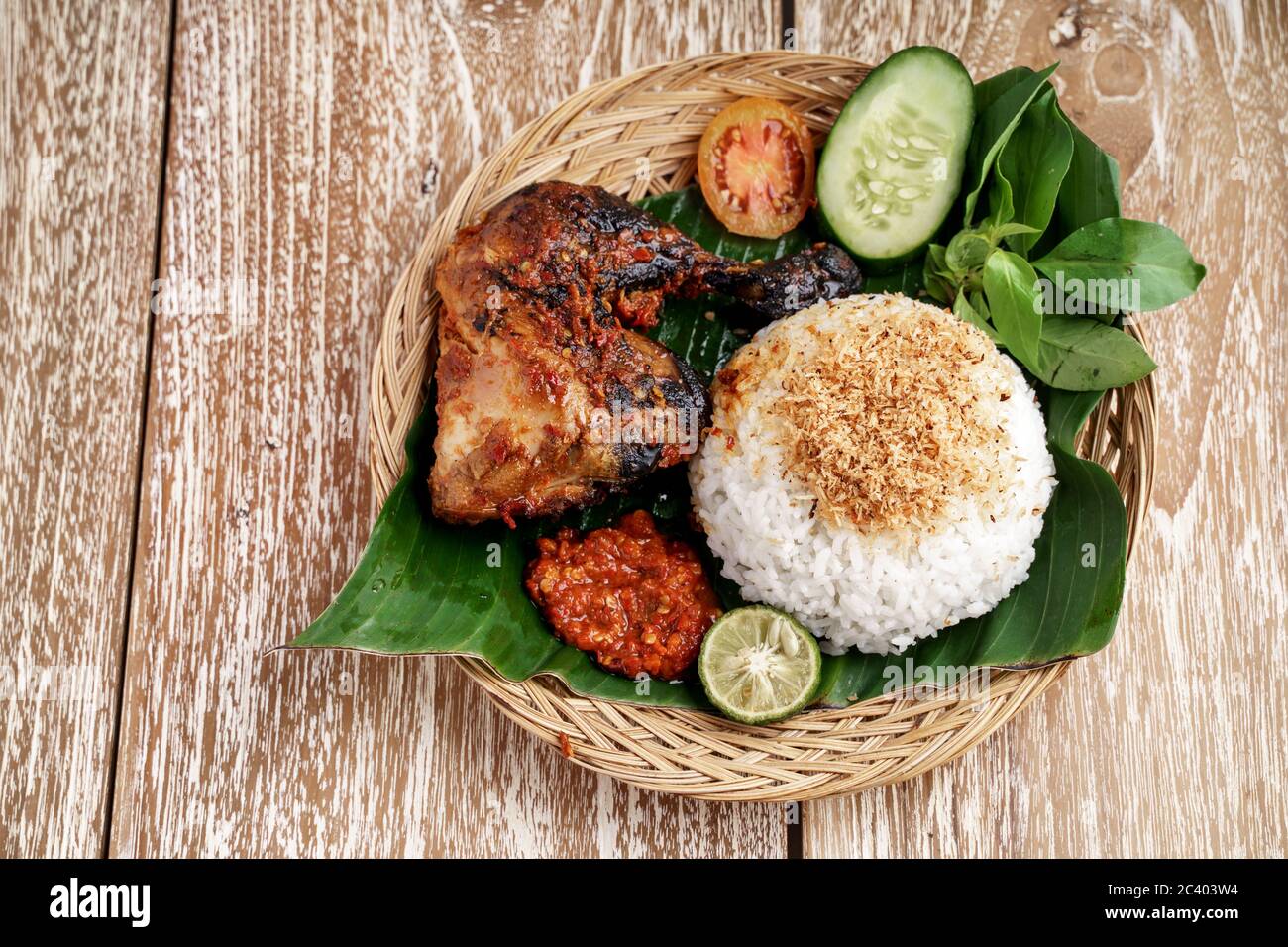 grilled chicken with white rice and sambal served on a traditional ...