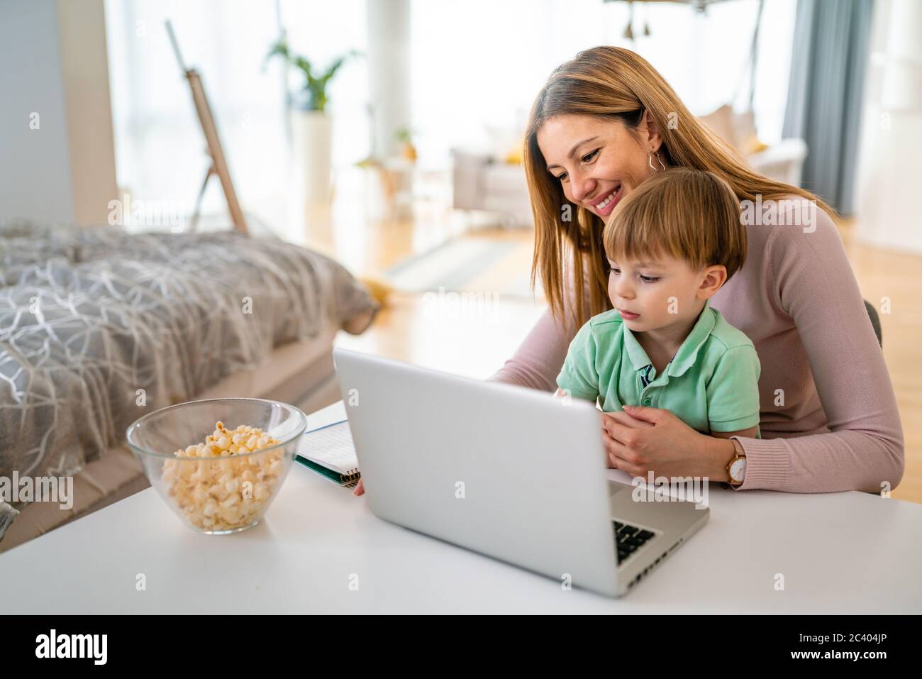 Busy family mother and child at home working on the computer Stock ...