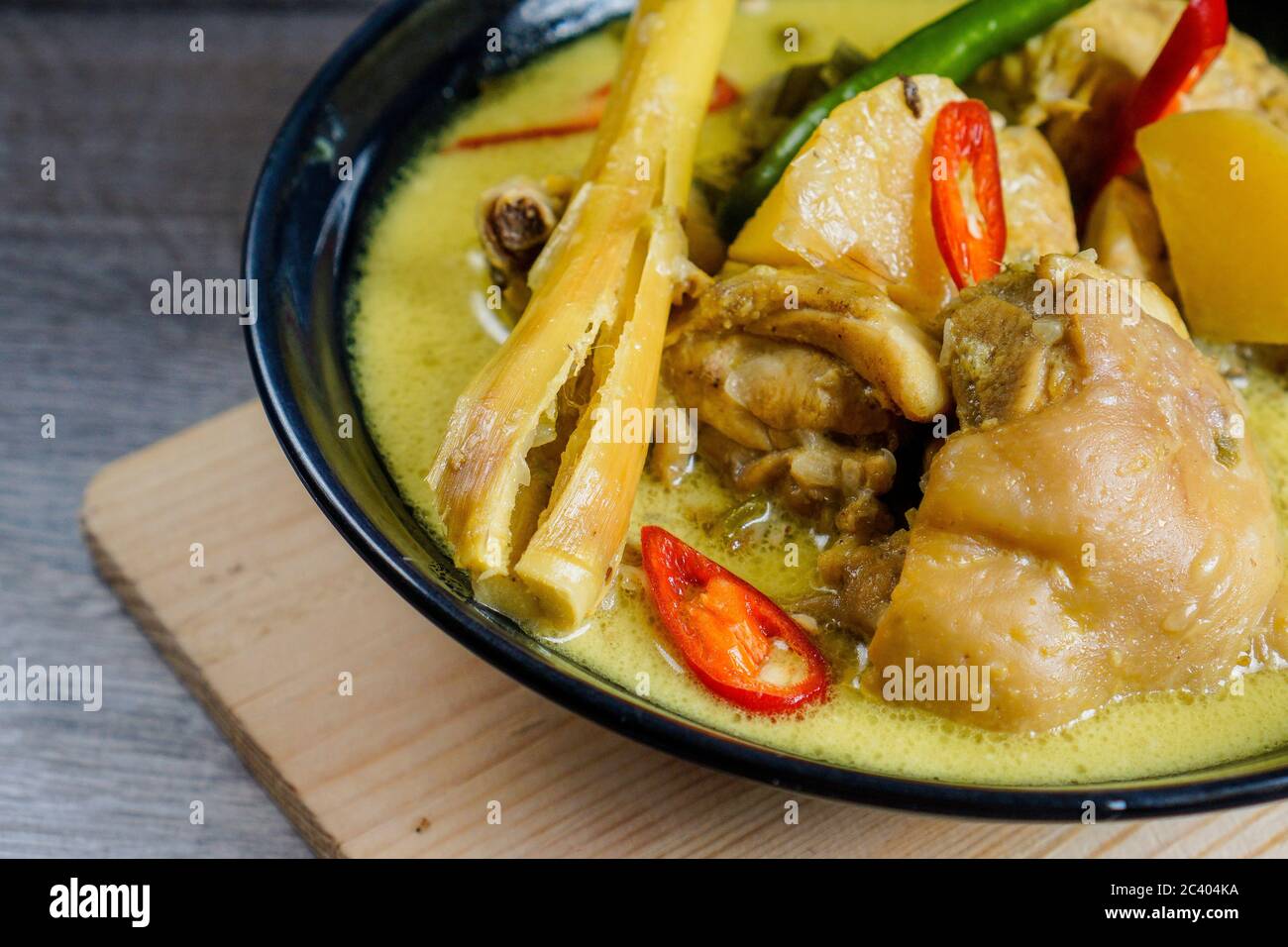 Chicken in turmeric coconut curry with spicy bird chili or thai chili ...