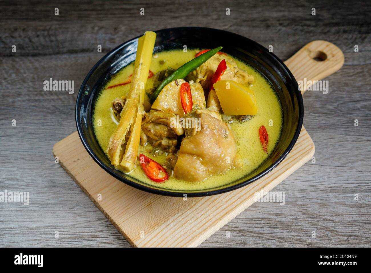 Chicken in turmeric coconut curry with spicy bird chili or thai chili ...